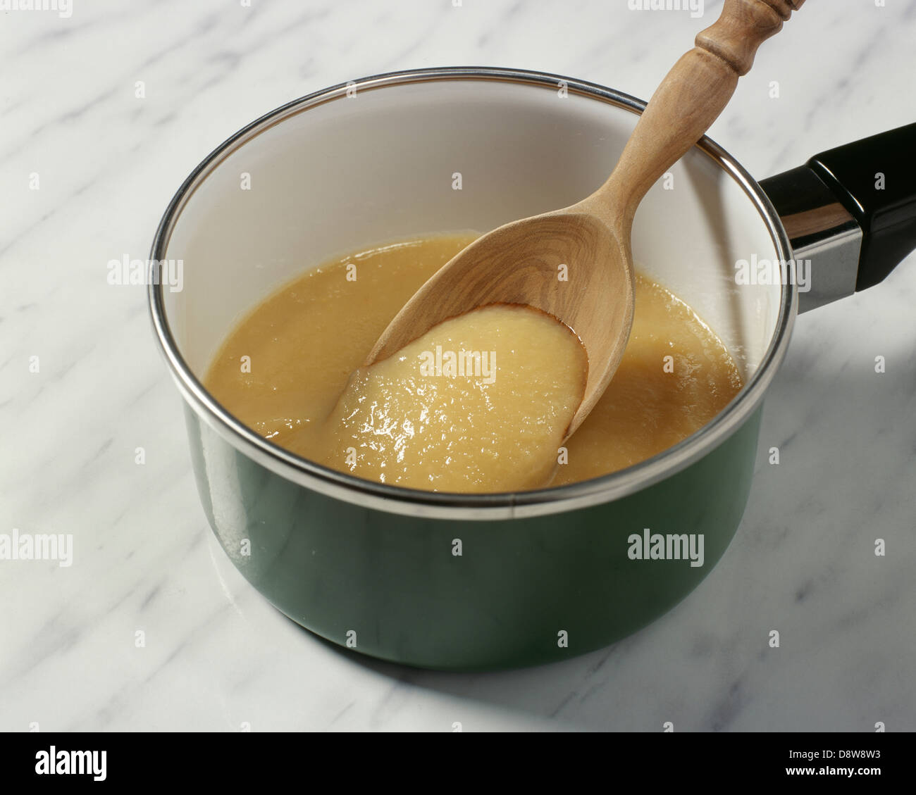 Heating the apple-banana puree Stock Photo - Alamy