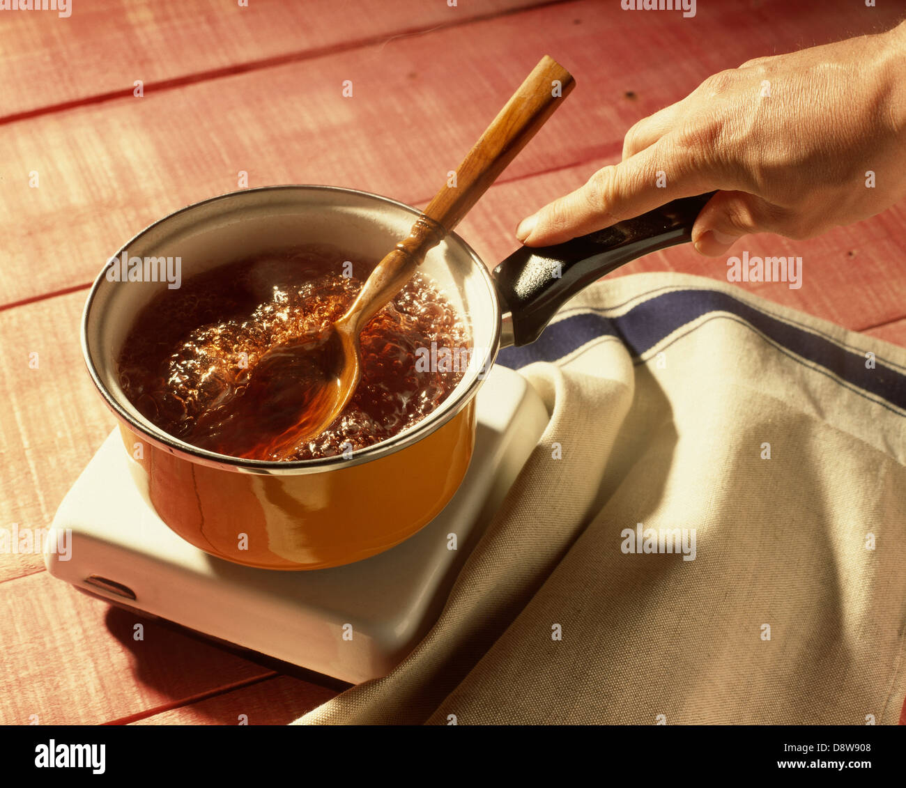 Boiling the filtered strawberry juice with sugar to make syrup Stock ...