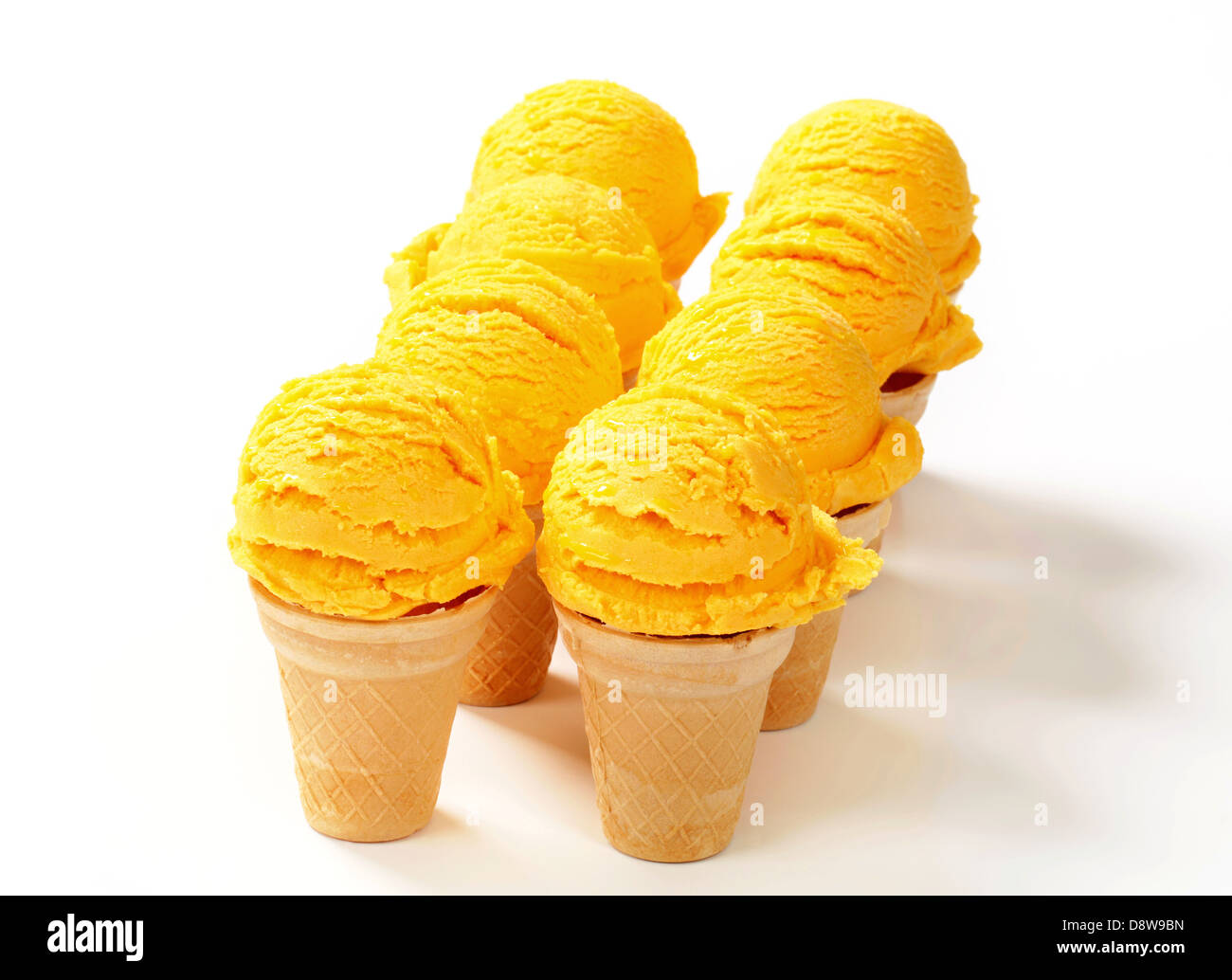 Scoops of yellow ice cream in wafer cones Stock Photo - Alamy