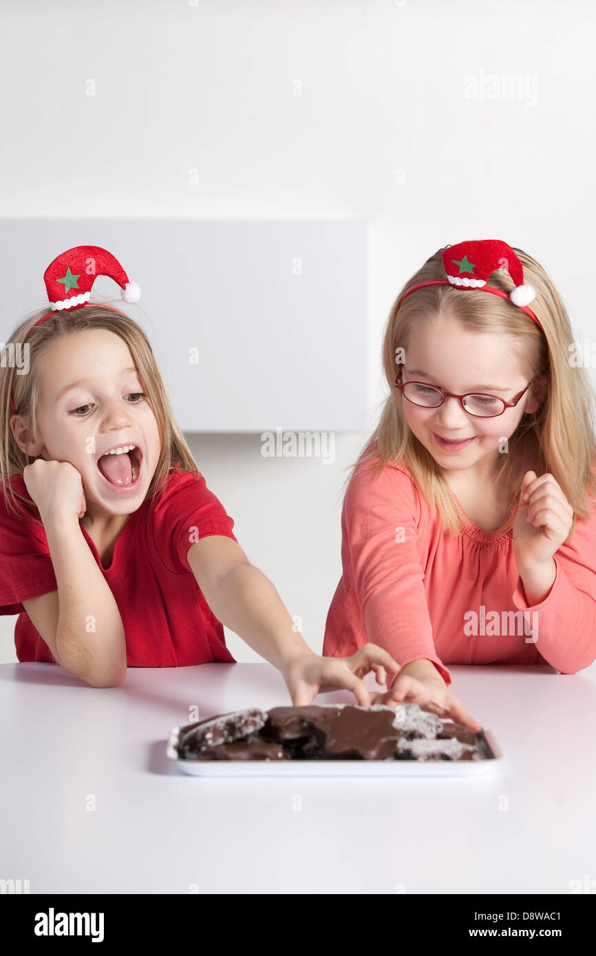 Young girls eating chocolate biscuits Stock Photo - Alamy
