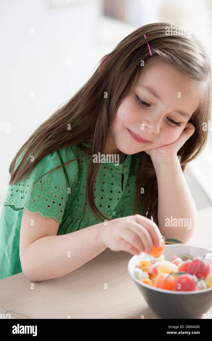 Young girl eating candies Stock Photo - Alamy