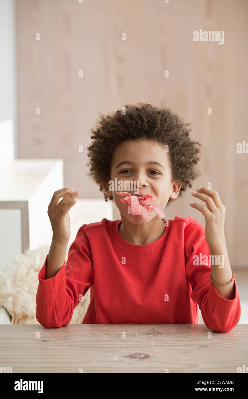 Boy eating playing and eating candy Stock Photo - Alamy