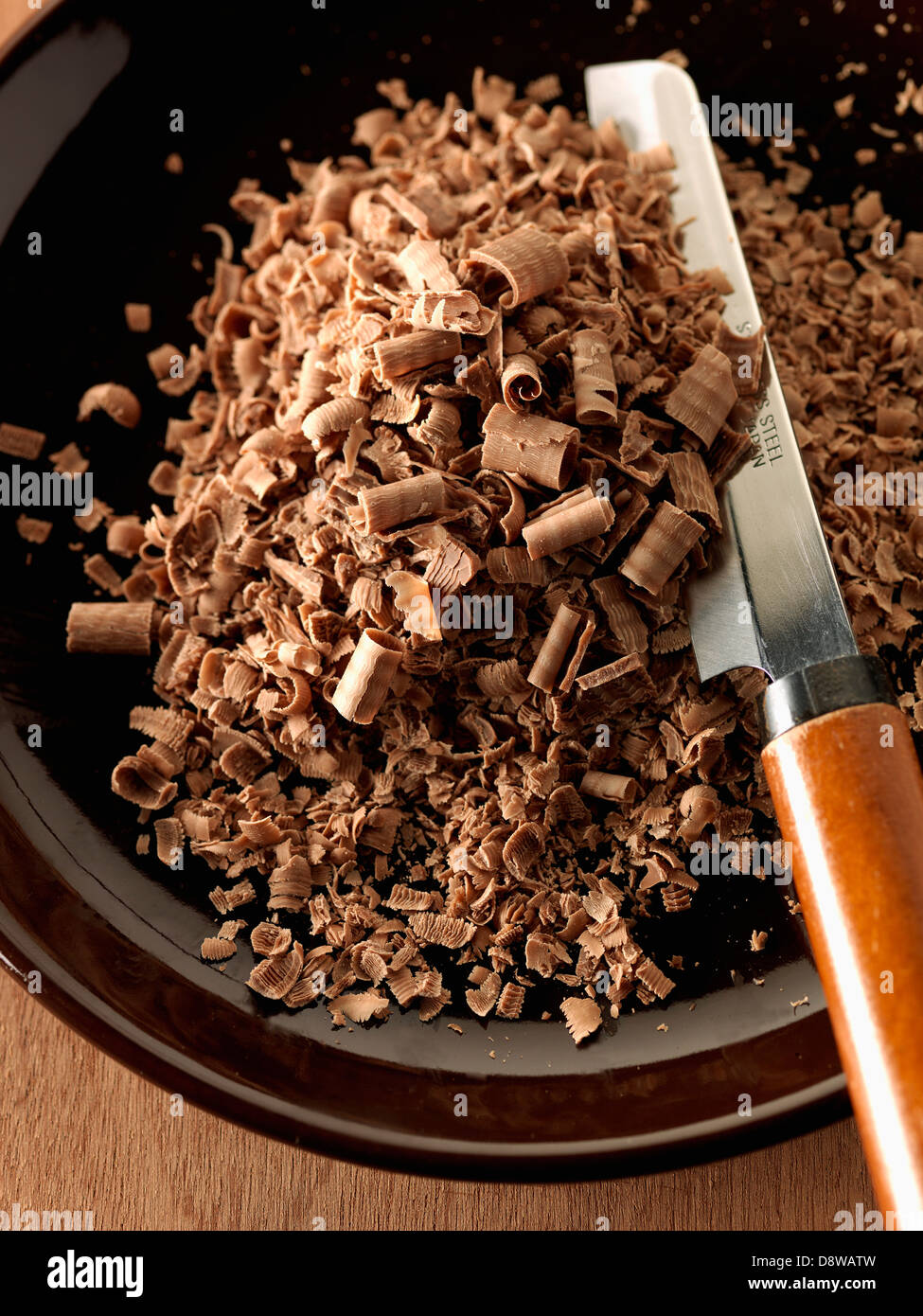 Making chocolate flakes with a knife Stock Photo - Alamy