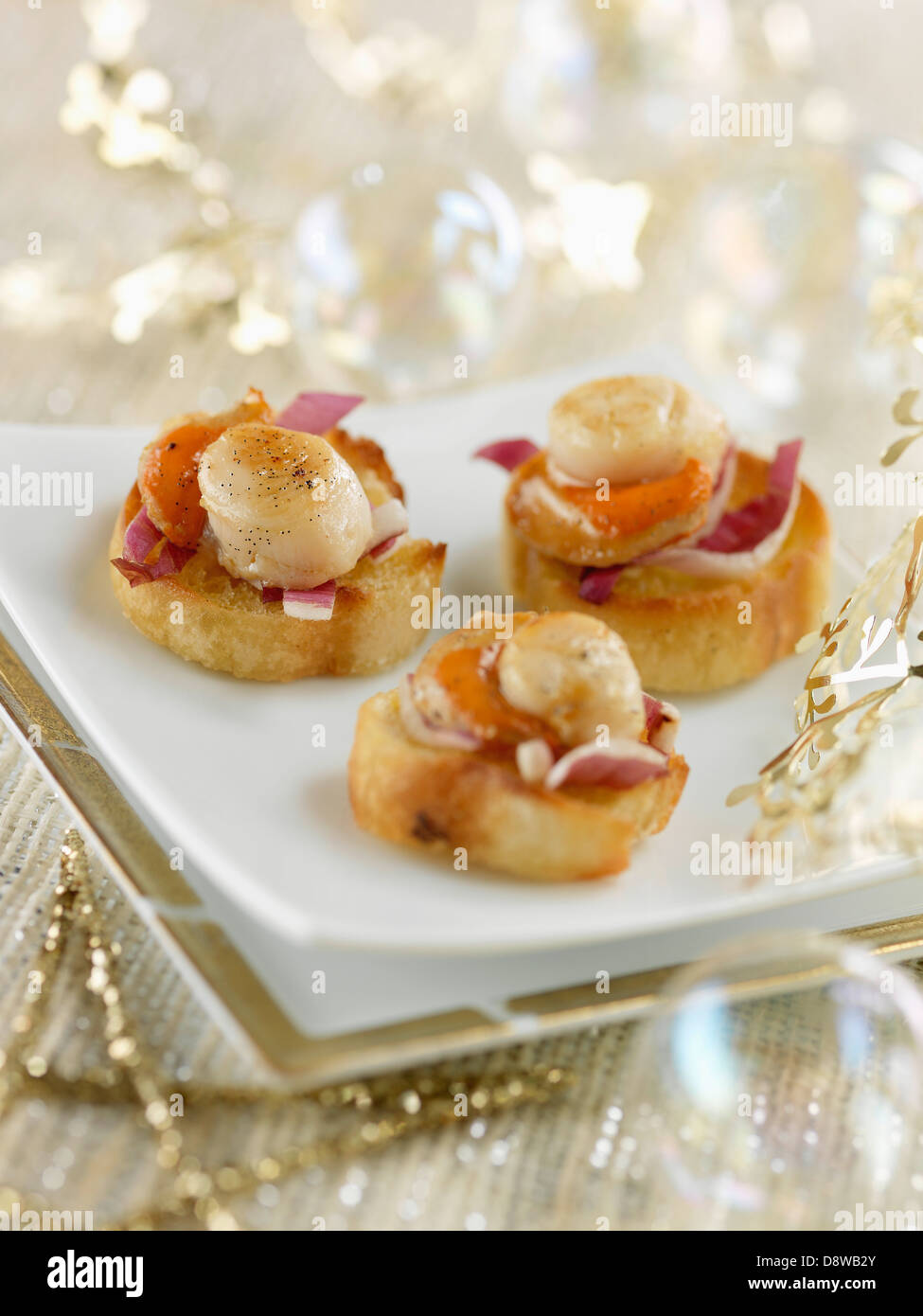 Vanilla-flavored petoncle scallops on small toasts Stock Photo - Alamy
