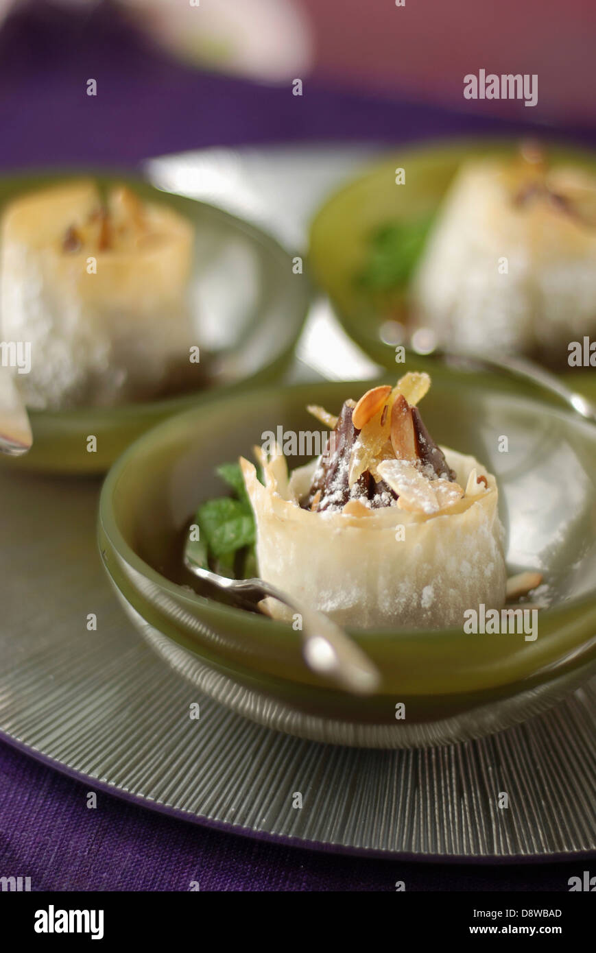 Fig wrapped in filo pastry with thinly sliced almonds Stock Photo - Alamy
