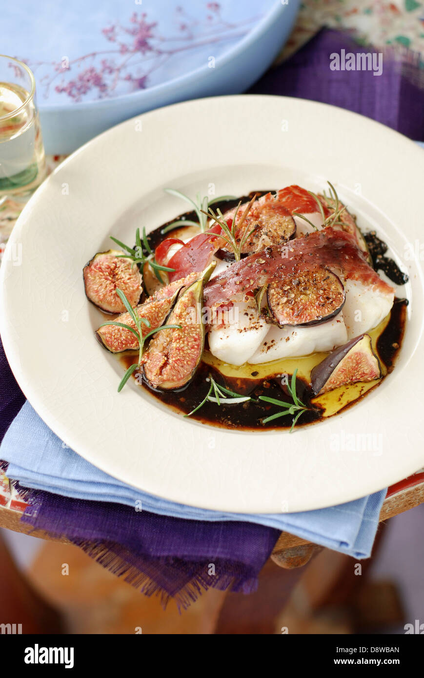Piece of cod with Spanish ham and roast figs Stock Photo - Alamy