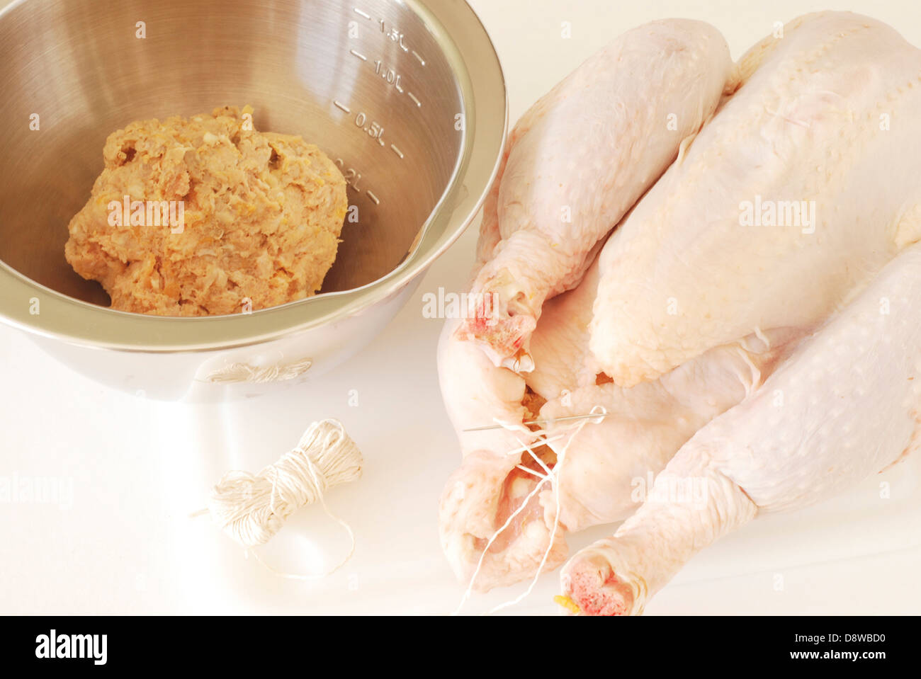 Stuffing the chicken Stock Photo - Alamy