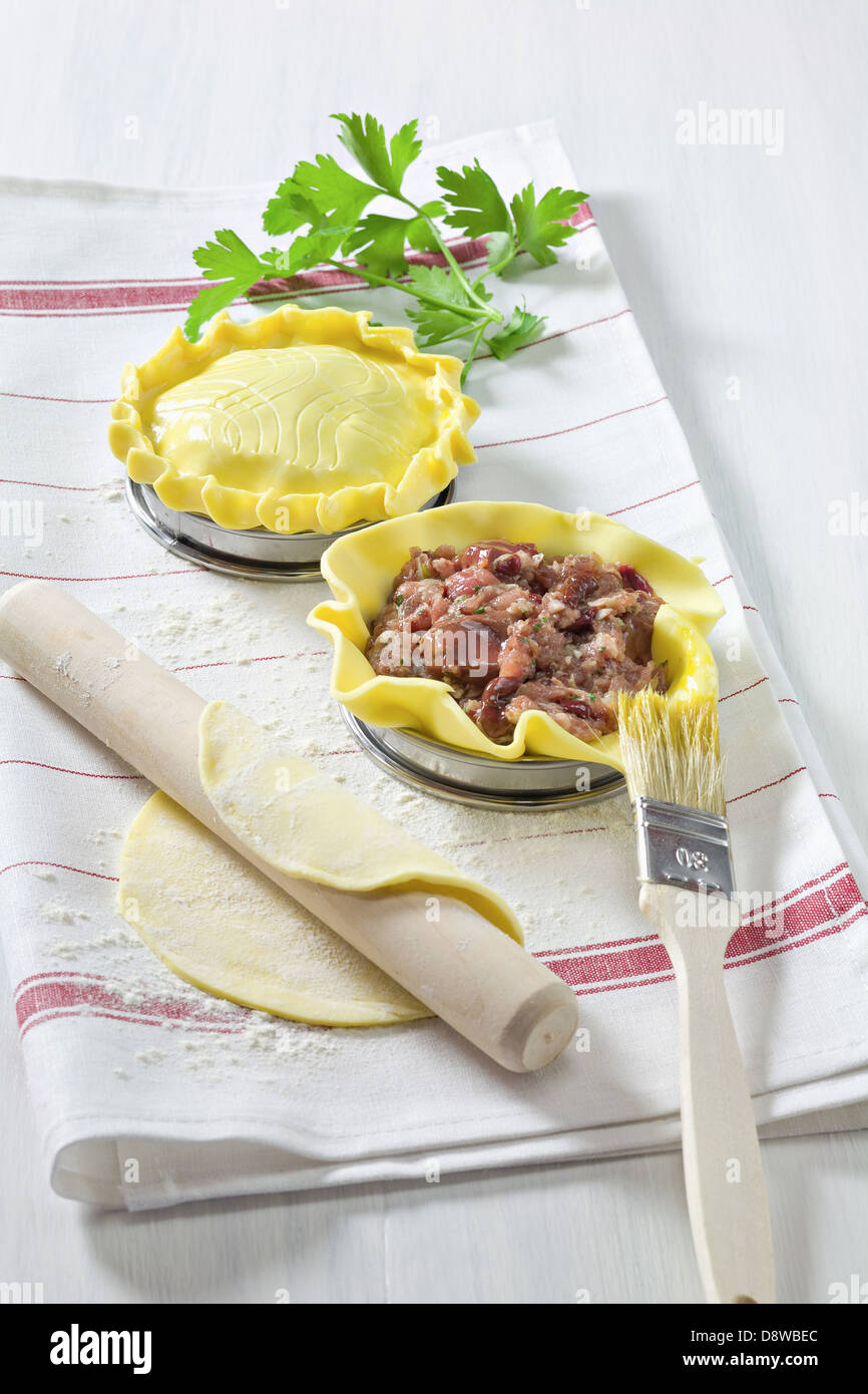 Preparing small crust patés Stock Photo - Alamy