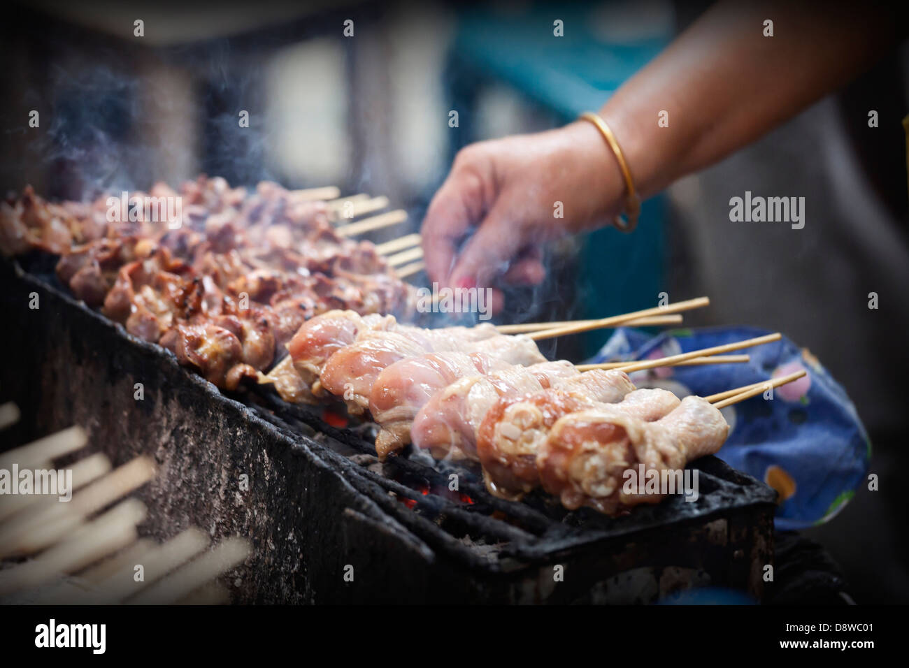 Grilling chicken on a street stall in Bangkok,Thailand Stock Photo - Alamy