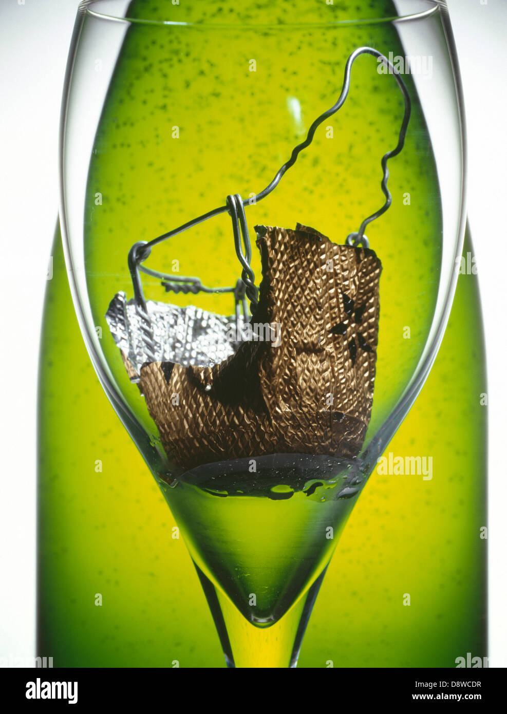 Wire-cap in a glass infront of wine bottle Stock Photo - Alamy