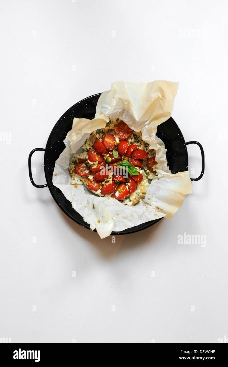 Cherry tomatoes with Brousse cheese cooked in wax paper Stock Photo - Alamy
