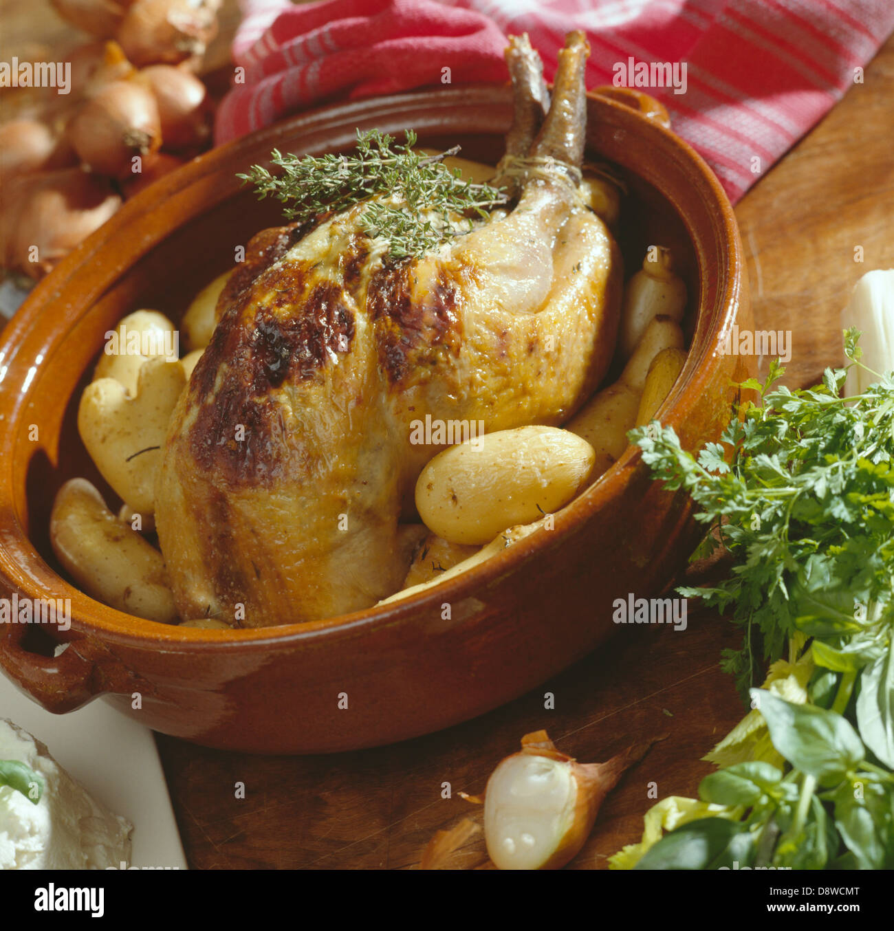 Roast guinea-fowl with potatoes and thyme Stock Photo - Alamy