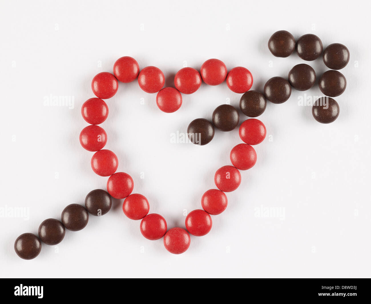 Heart and arrow shape made from candies,studio shot Stock Photo - Alamy