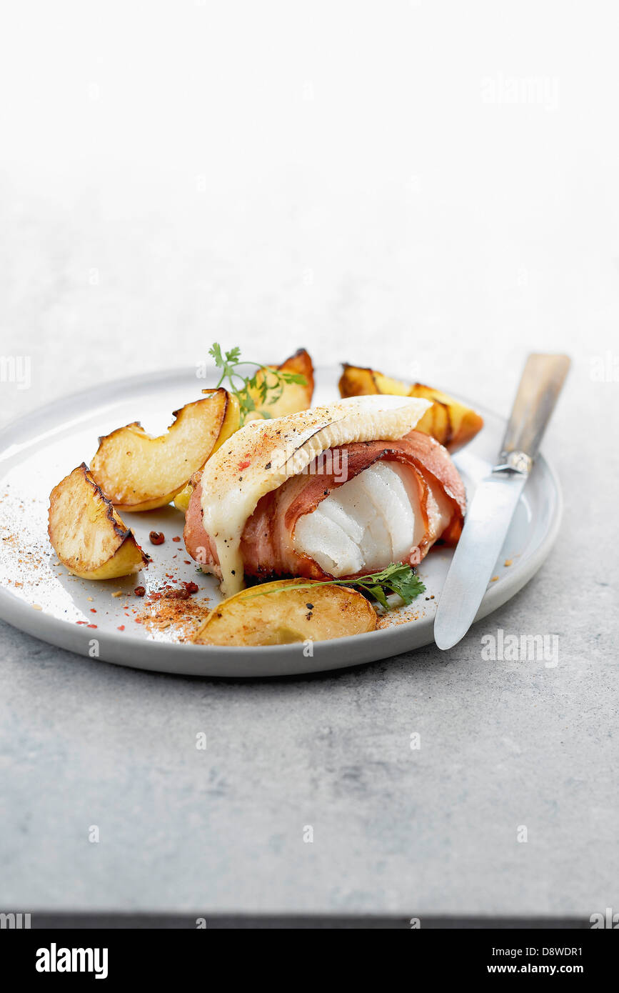 Piece of cod wrapped in bacon and topped with grilled Munster cheese ...