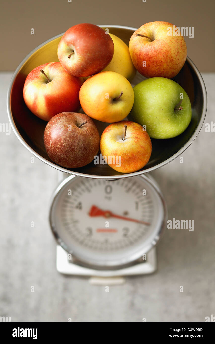 Assorted apples on scales Stock Photo - Alamy