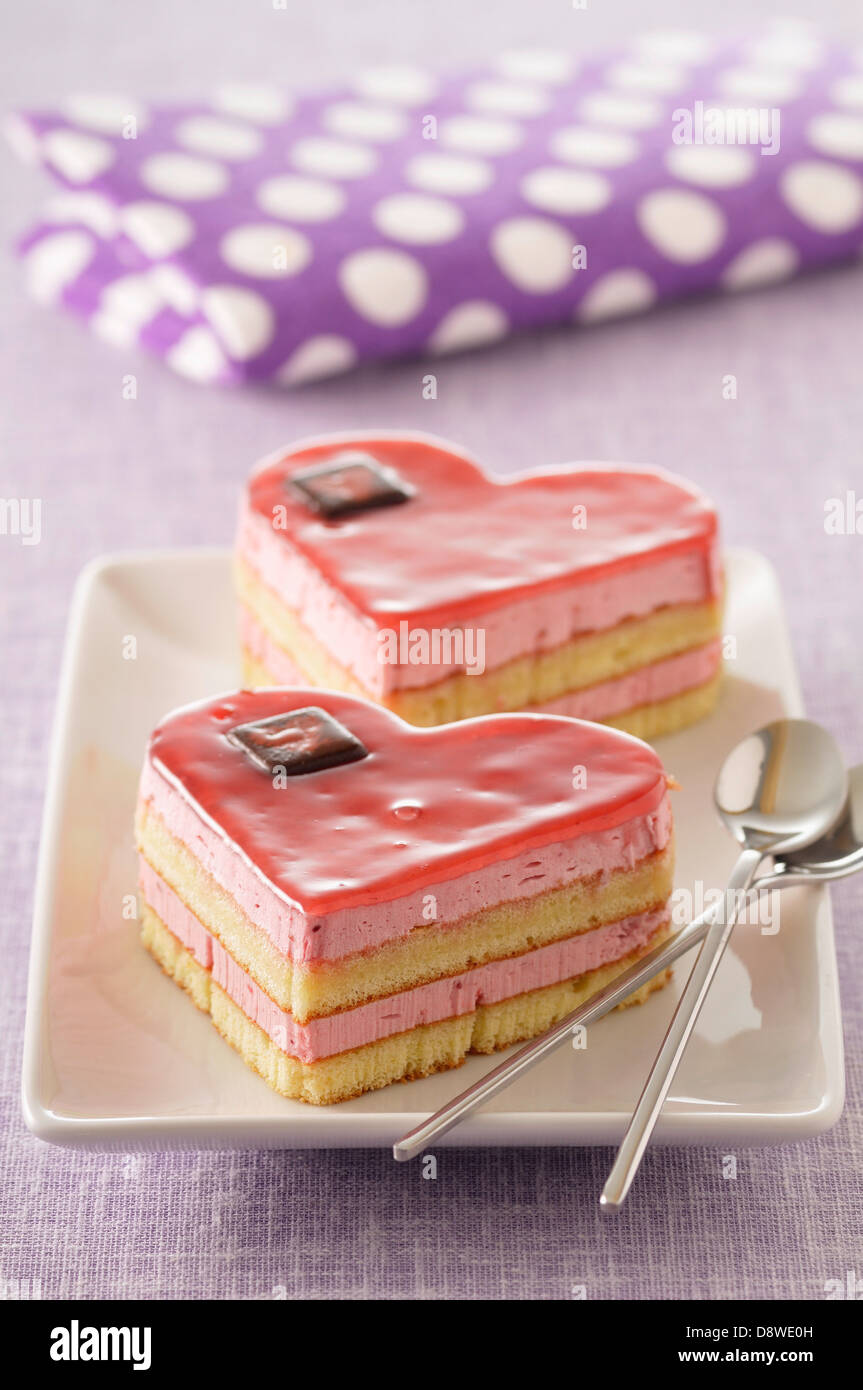 Raspberry mousse heart-shaped sponge cakes Stock Photo - Alamy