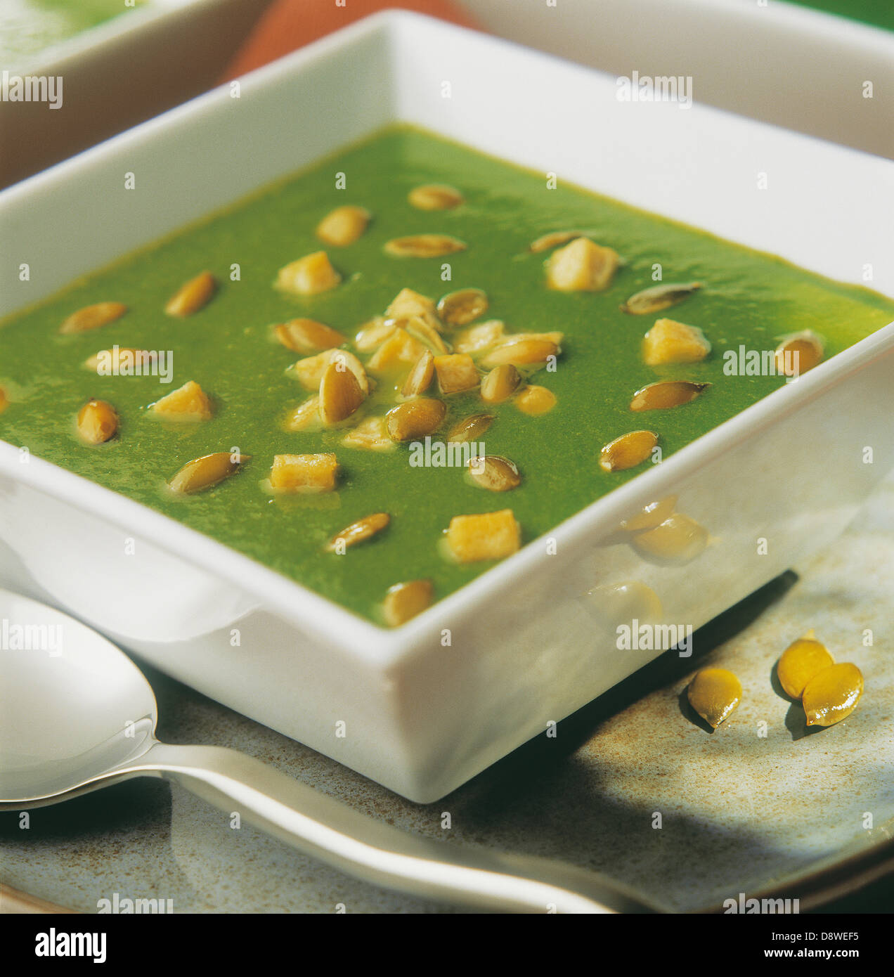 Pea soup with squash seeds Stock Photo - Alamy