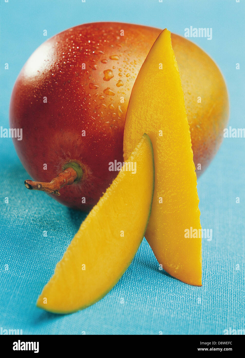 Whole and sliced mango Stock Photo - Alamy