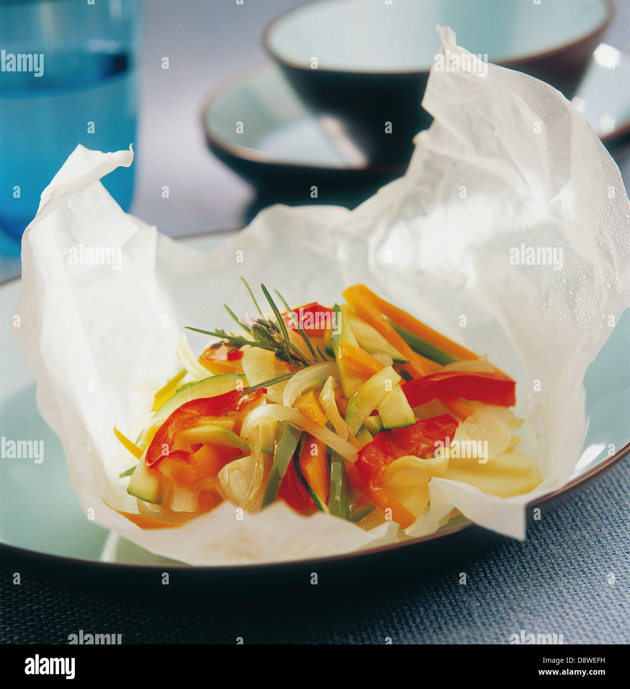 Fish and vegetables cooked in wax paper Stock Photo - Alamy