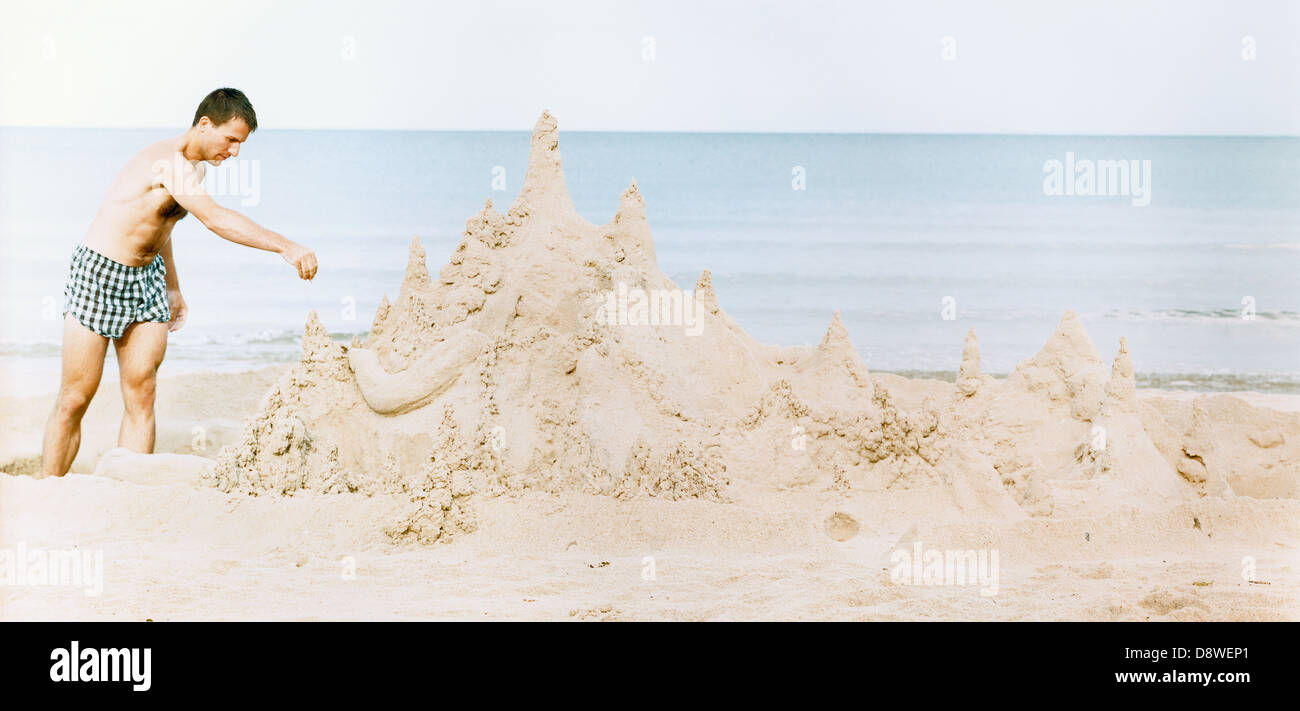 A man building a sand castle, Skane, Sweden Stock Photo - Alamy