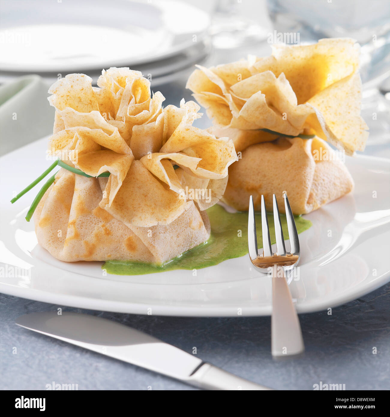 Salmon crepe purses ,spinach sauce Stock Photo - Alamy
