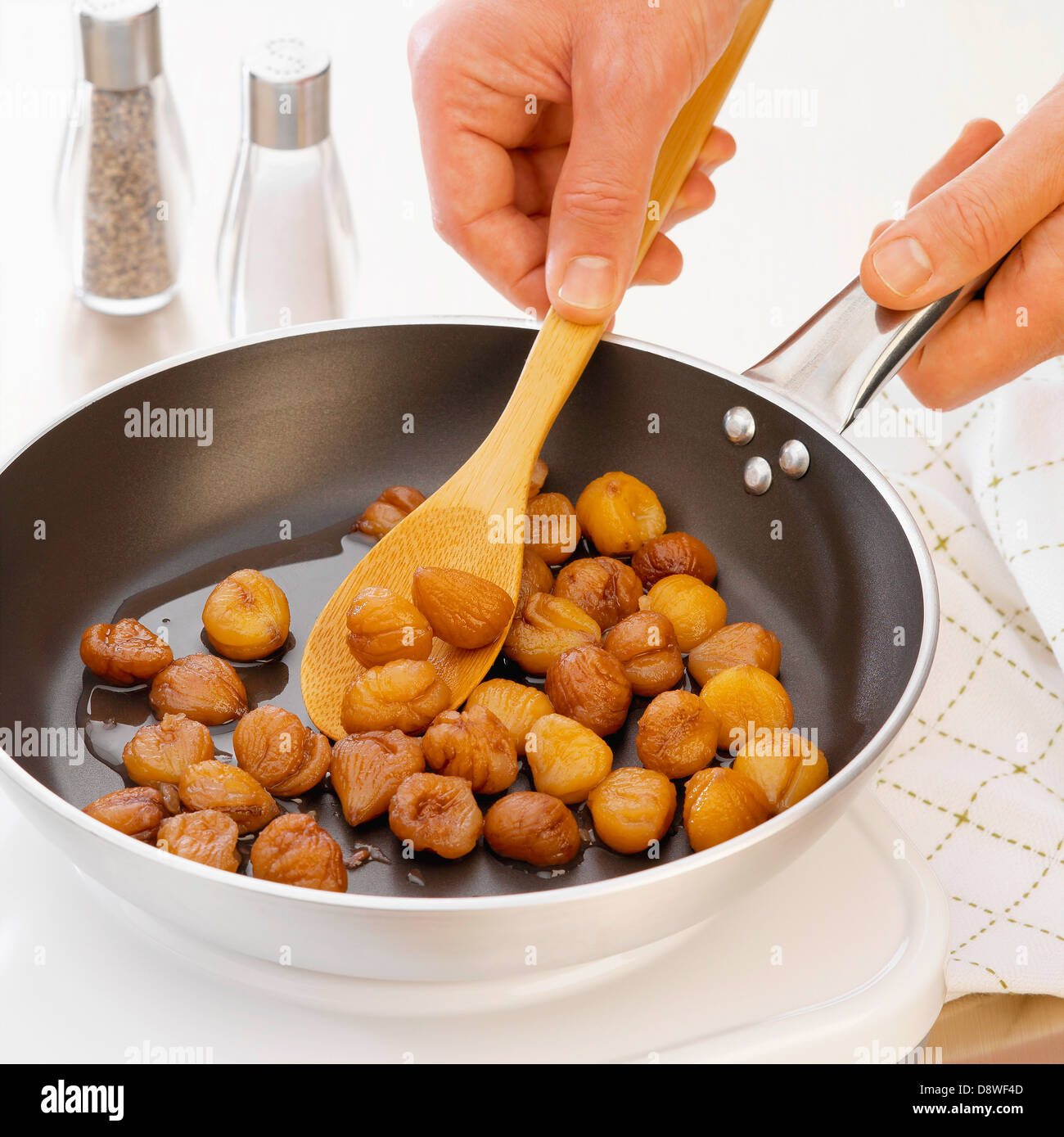 Pan-frying the chestnuts Stock Photo - Alamy