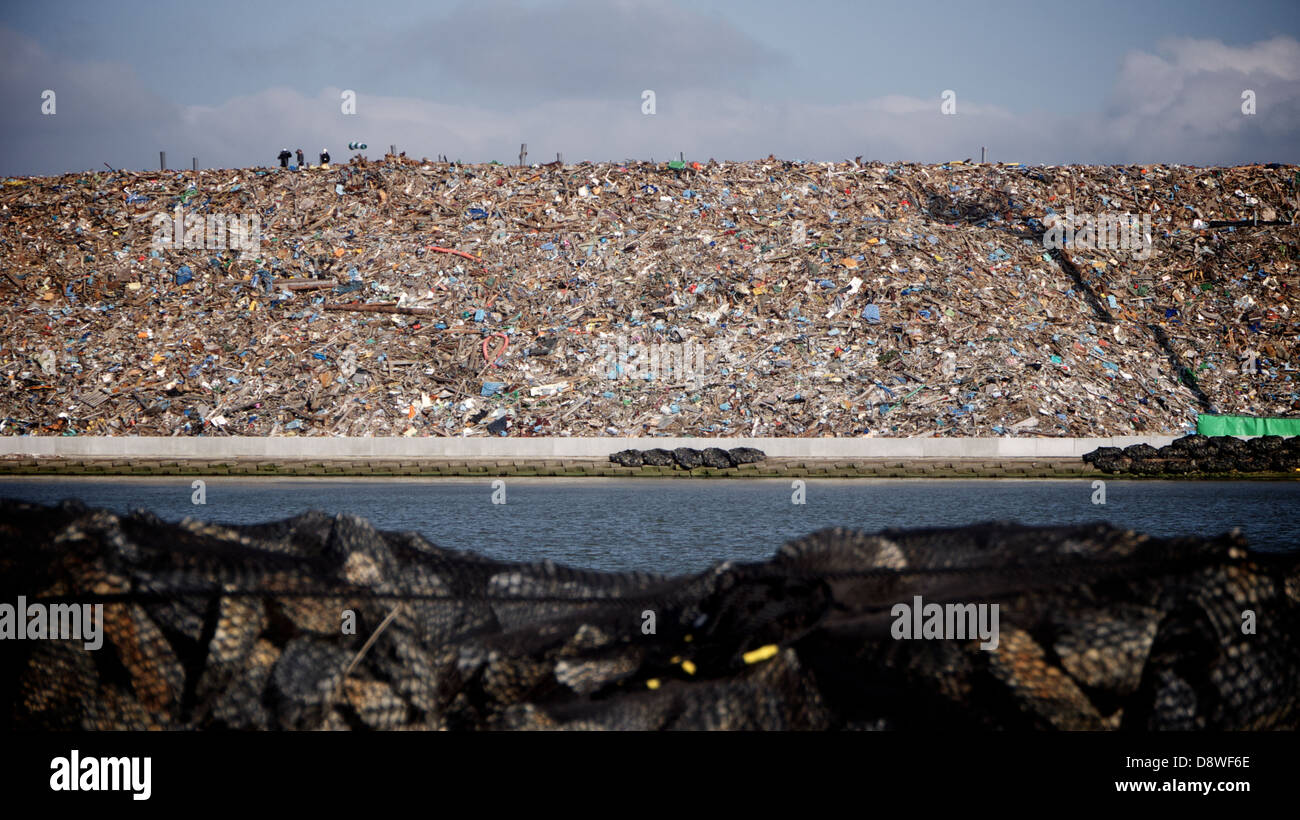 Massive wall of debris piled up along the Ishinomaki Bay. Despite so ...