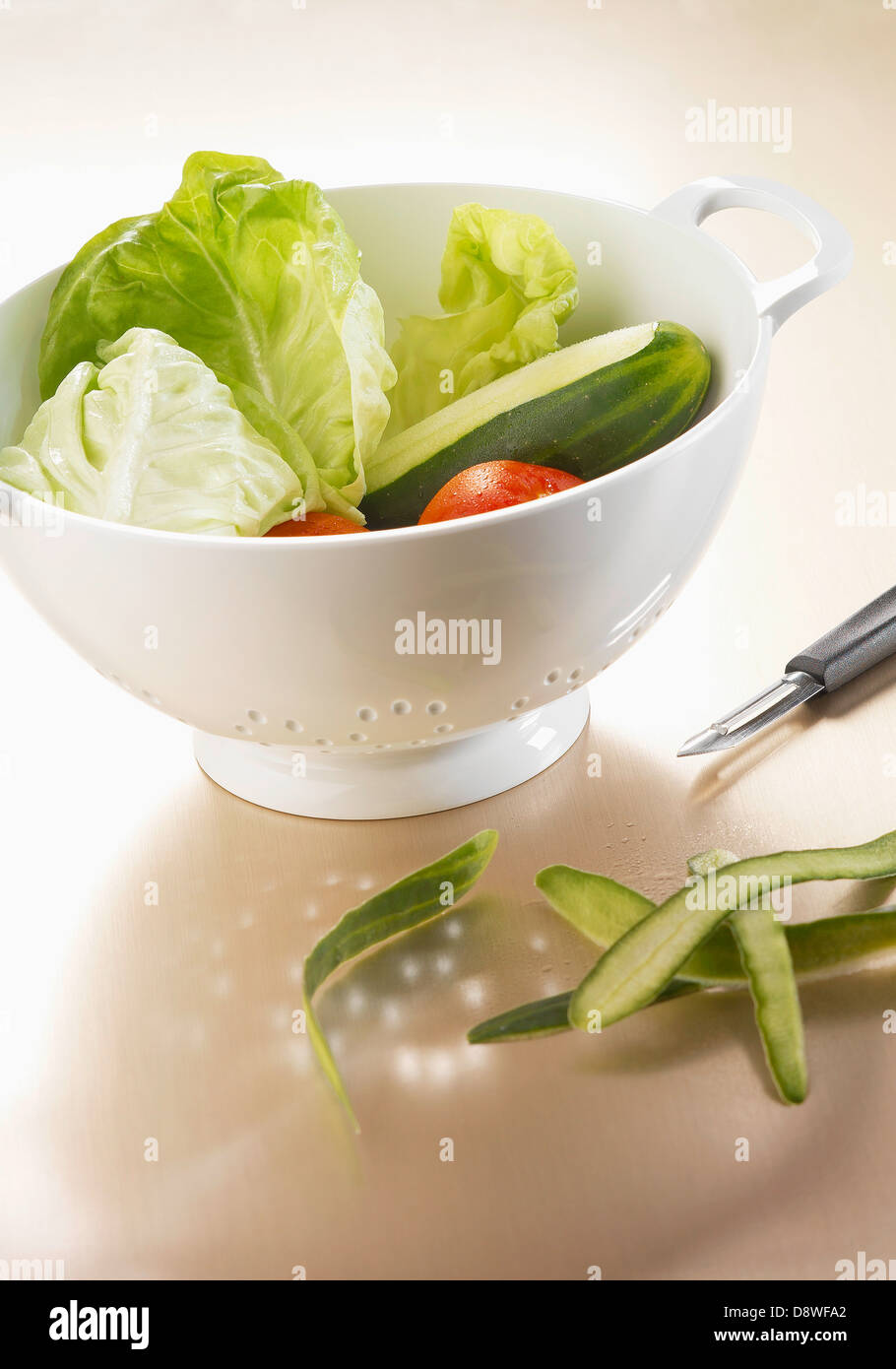 Lettuce,tomatoes and peeled cucumber in a colander Stock Photo - Alamy