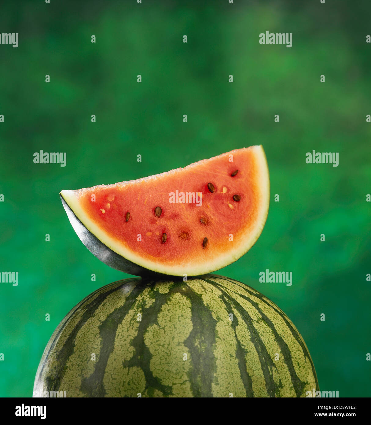 Whole and a slice of watermelon Stock Photo - Alamy
