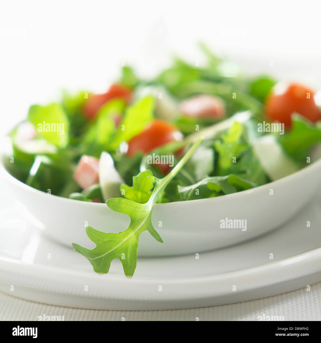 Rocket lettuce,cherry tomato and diced bacon salad Stock Photo - Alamy