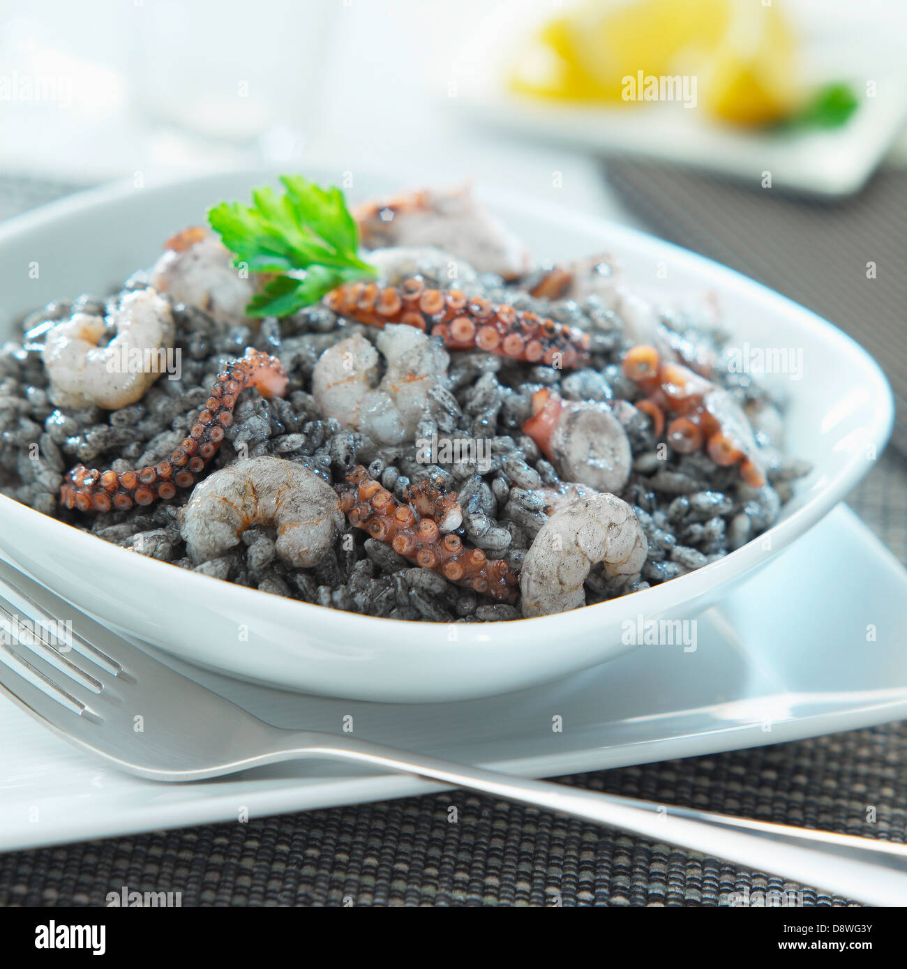 Black rice with octopus and shrimps Stock Photo - Alamy