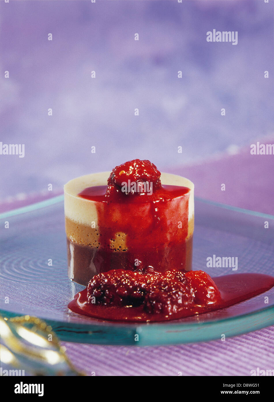 Three-colored chocolate dessert with summer fruit puree Stock Photo - Alamy