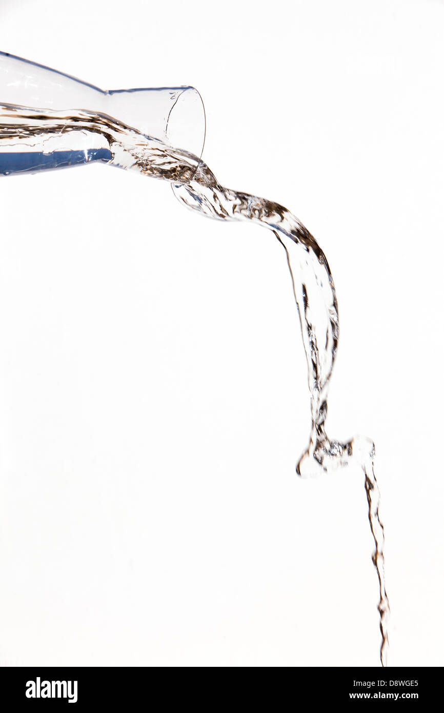 Water is pouring on white background, studio shot Stock Photo - Alamy