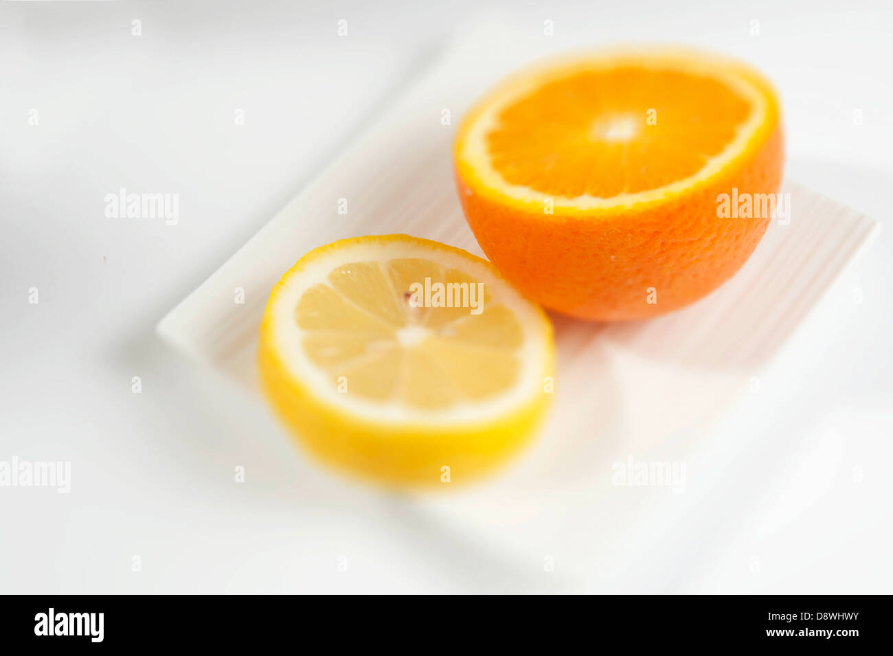 Half an orange and a slice of lemon Stock Photo - Alamy