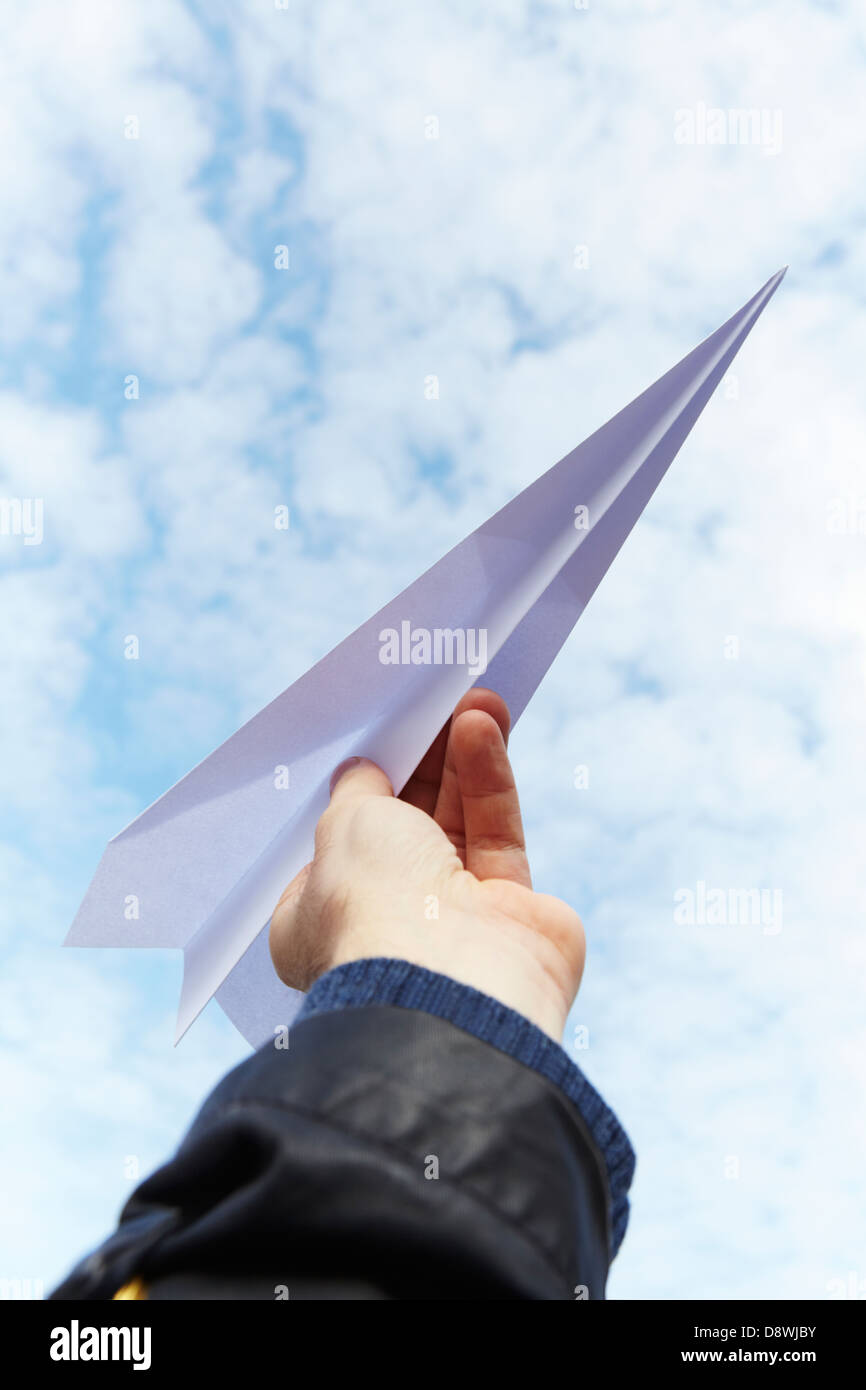 Hand holding paper plane Stock Photo - Alamy