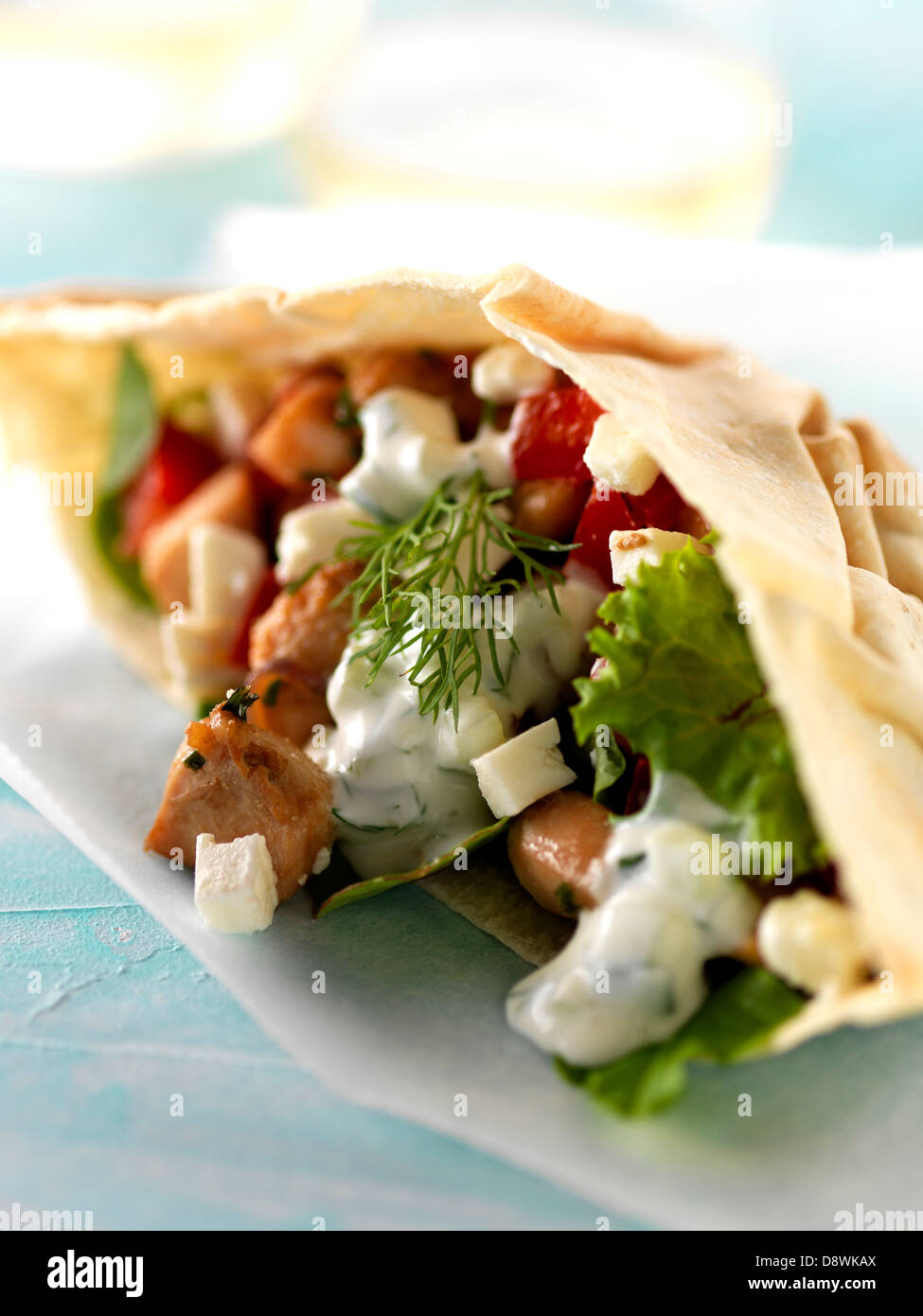 Chicken,tomato,feta and lettuce pitta bread sandwich with white yoghurt ...