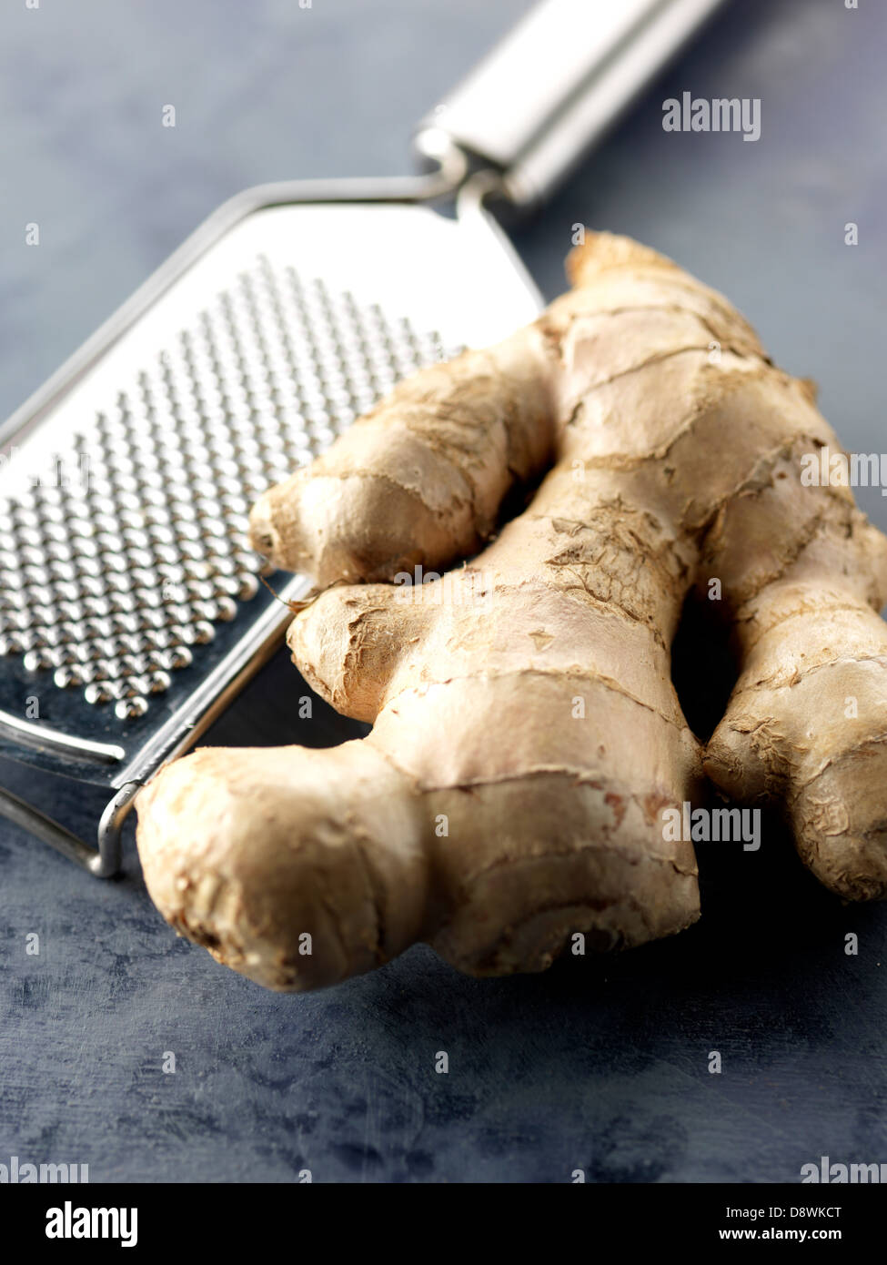 Ginger root and grater Stock Photo - Alamy