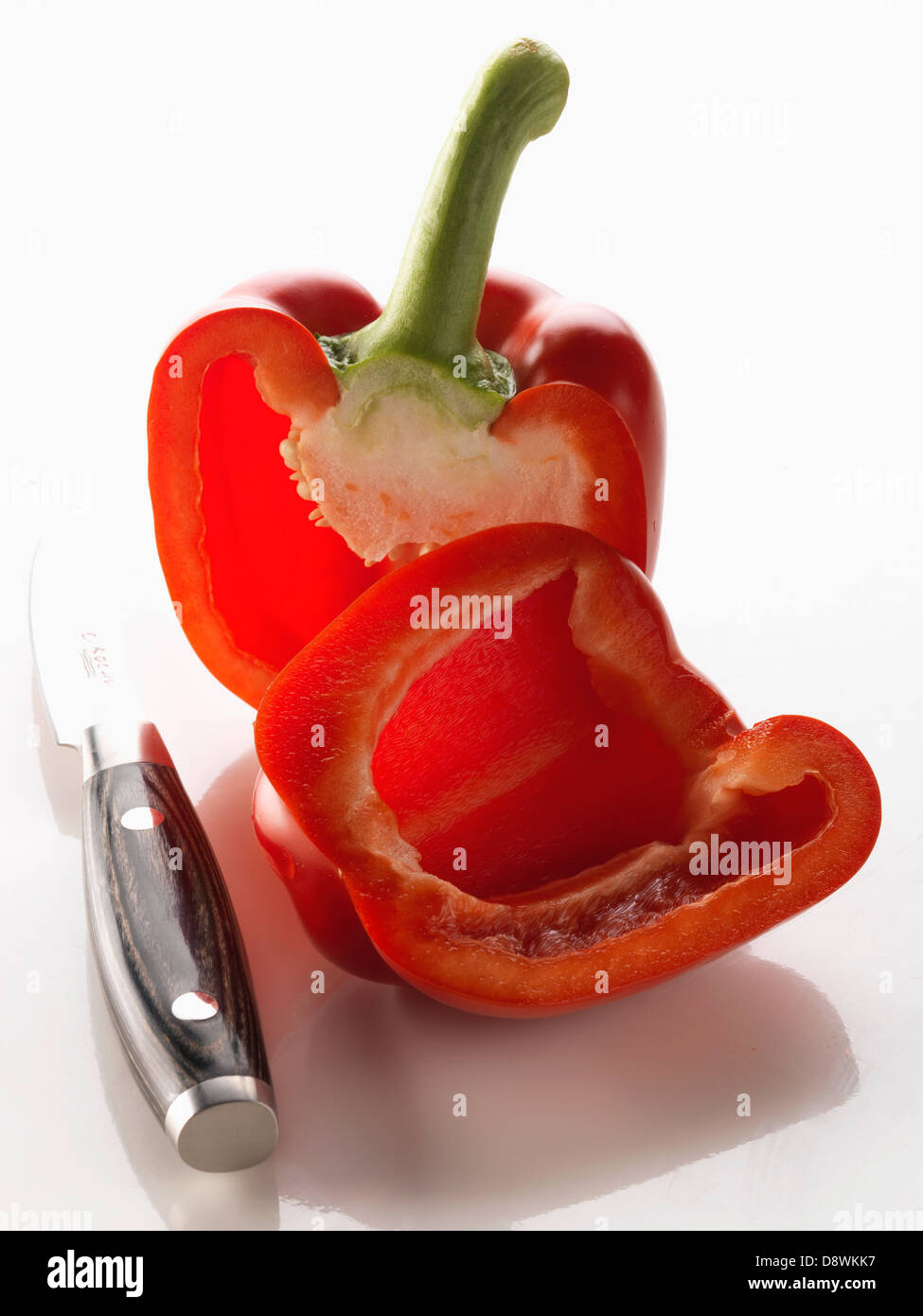 Red pepper cut in half and knife Stock Photo - Alamy