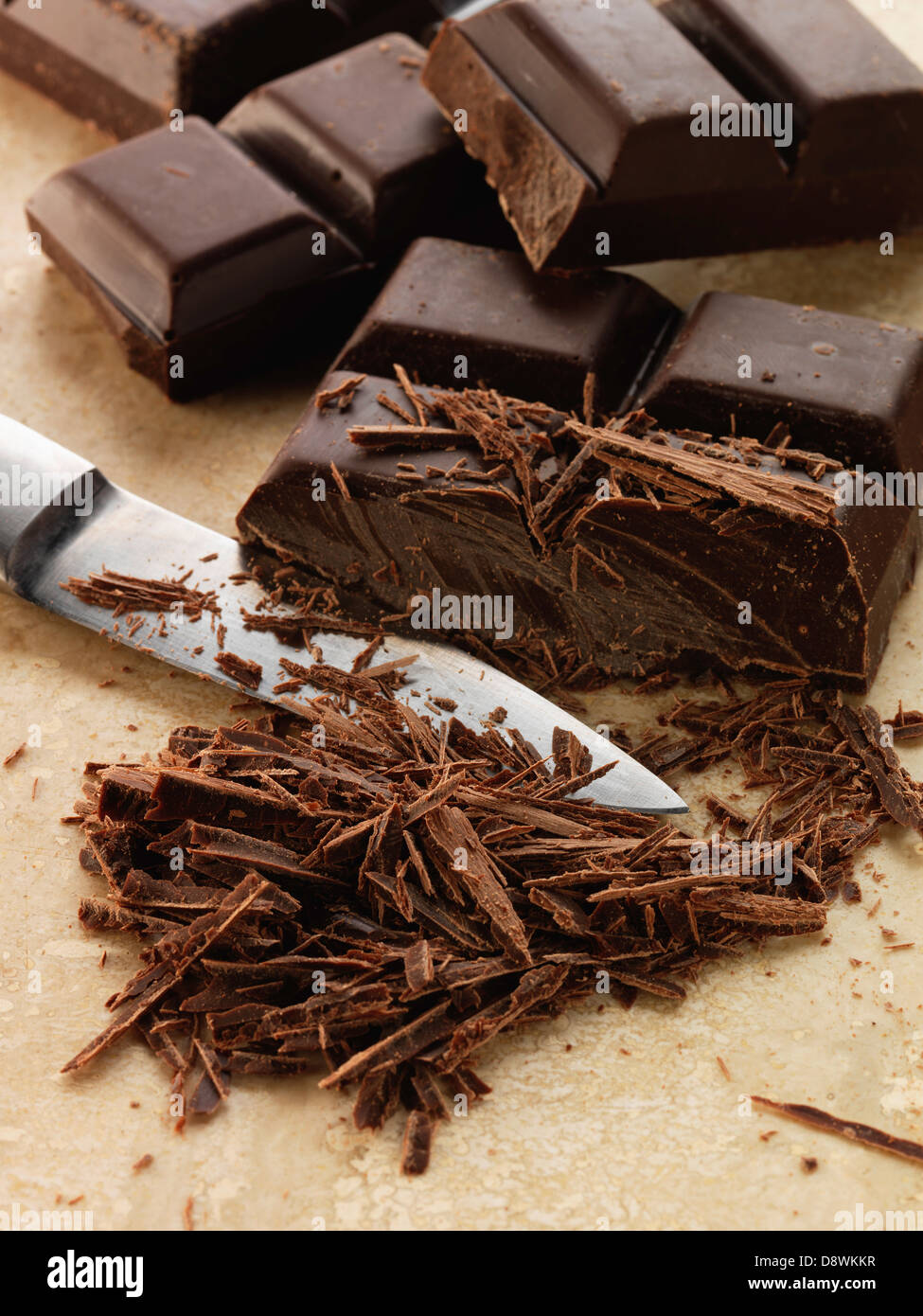 Making chocolate flakes with a knife Stock Photo - Alamy