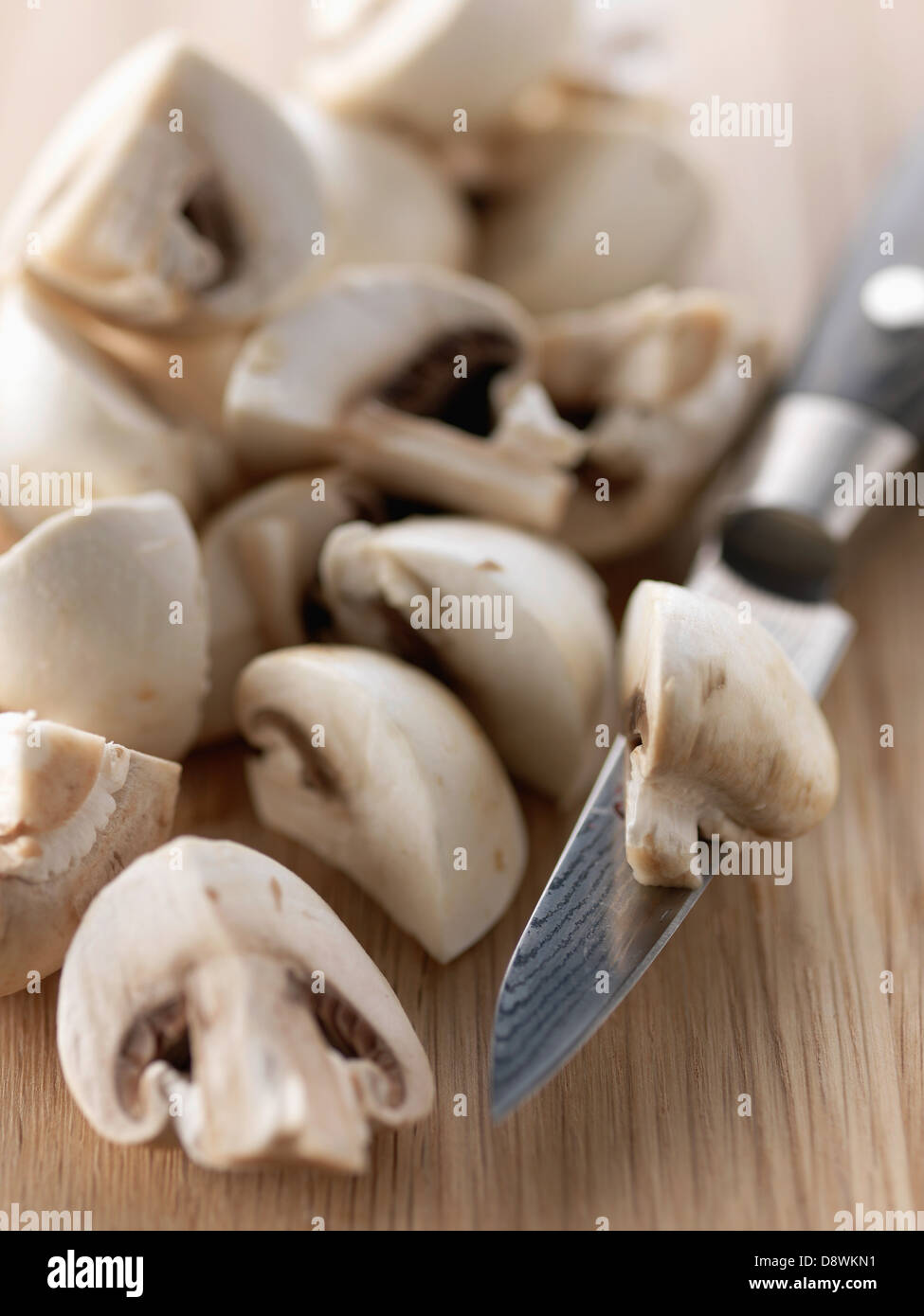 Slicing the button mushrooms Stock Photo - Alamy