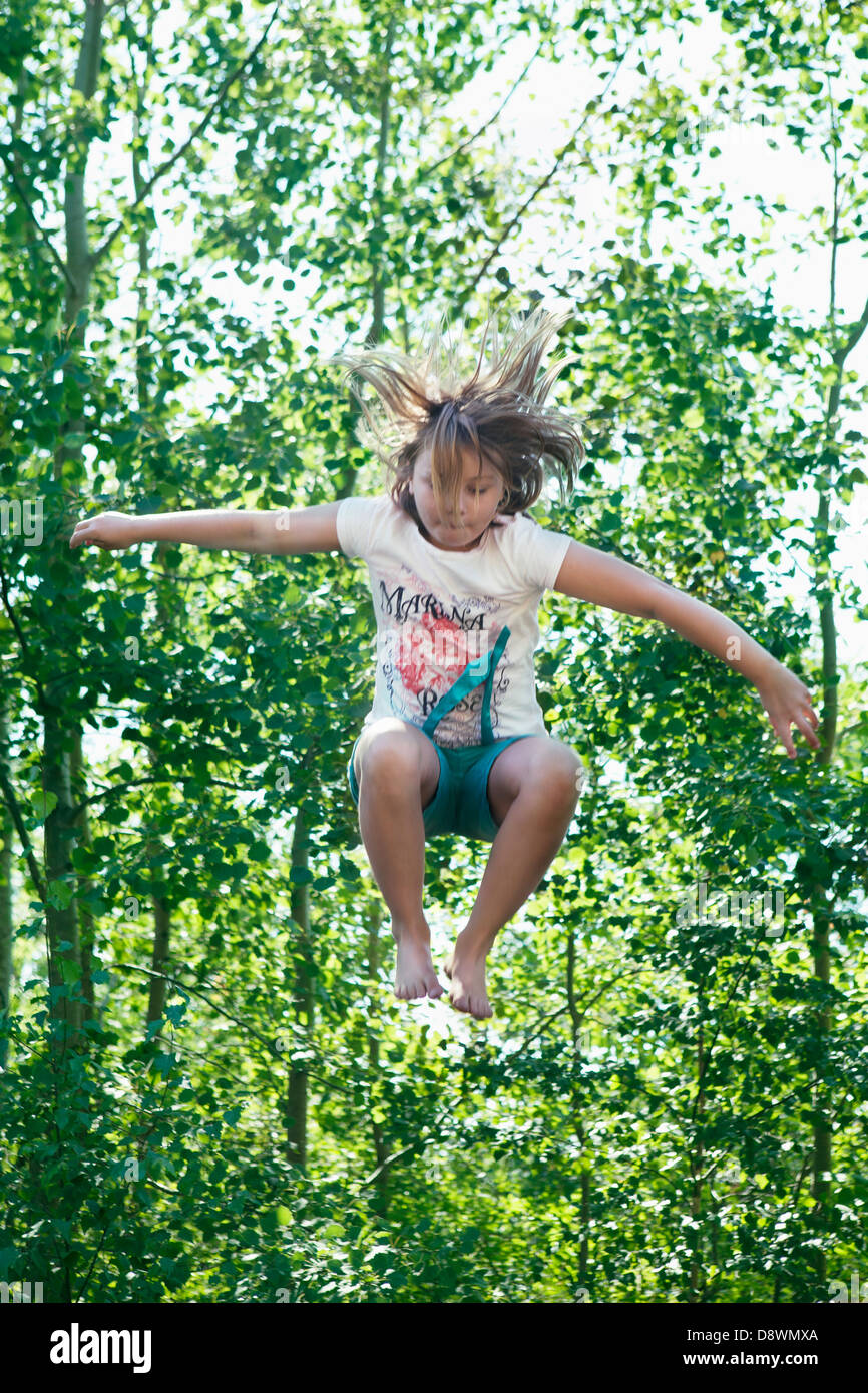 Girl jumping in forest Stock Photo - Alamy
