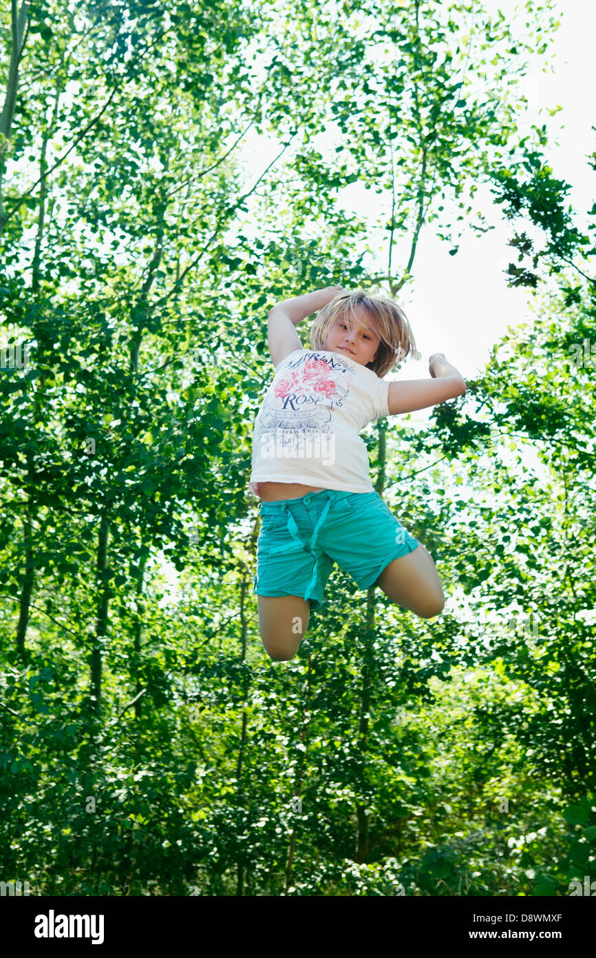 Girl jumping in forest Stock Photo - Alamy