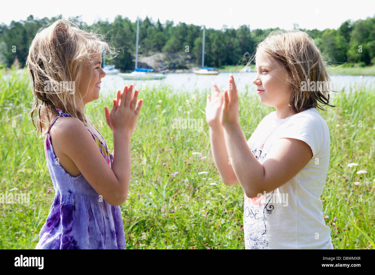 Girls clapping hands Stock Photo - Alamy