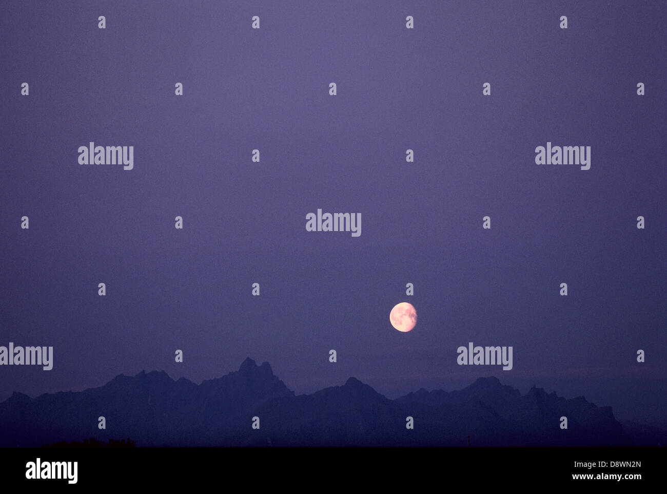 Full moon over mountains Stock Photo - Alamy