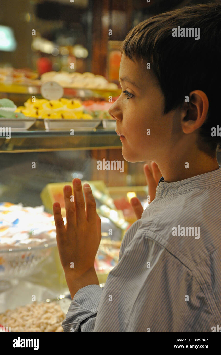 Young boy infront of a window display in a candy store Stock Photo - Alamy