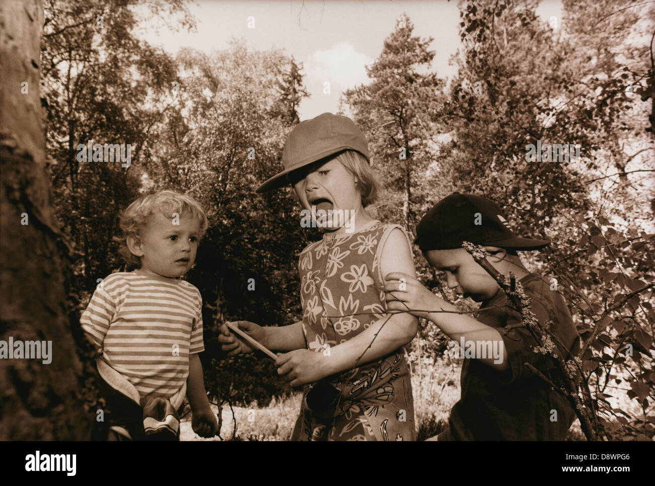 Three children playing and crying Stock Photo - Alamy