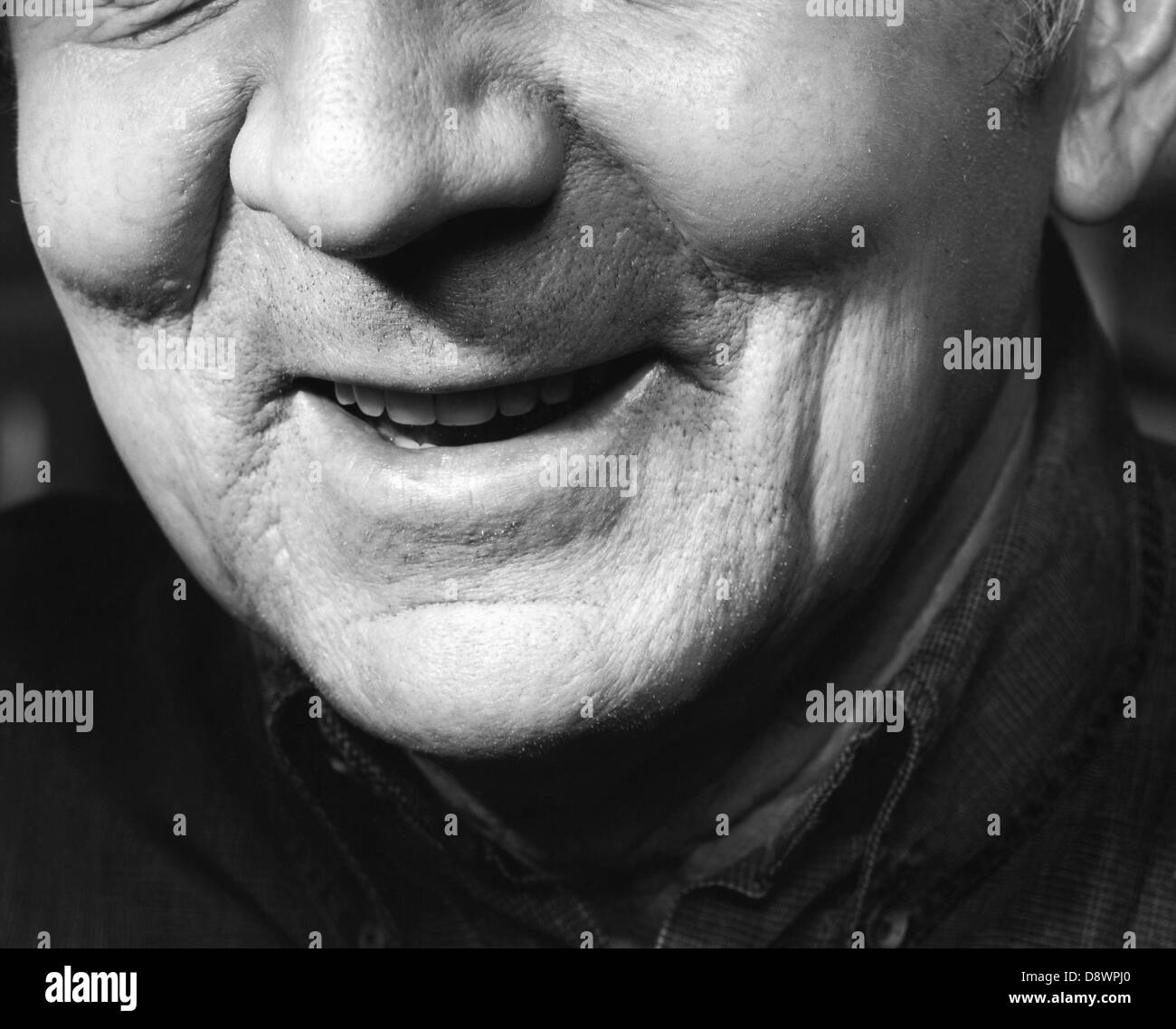 Smiling old man on black Black and White Stock Photos & Images - Alamy