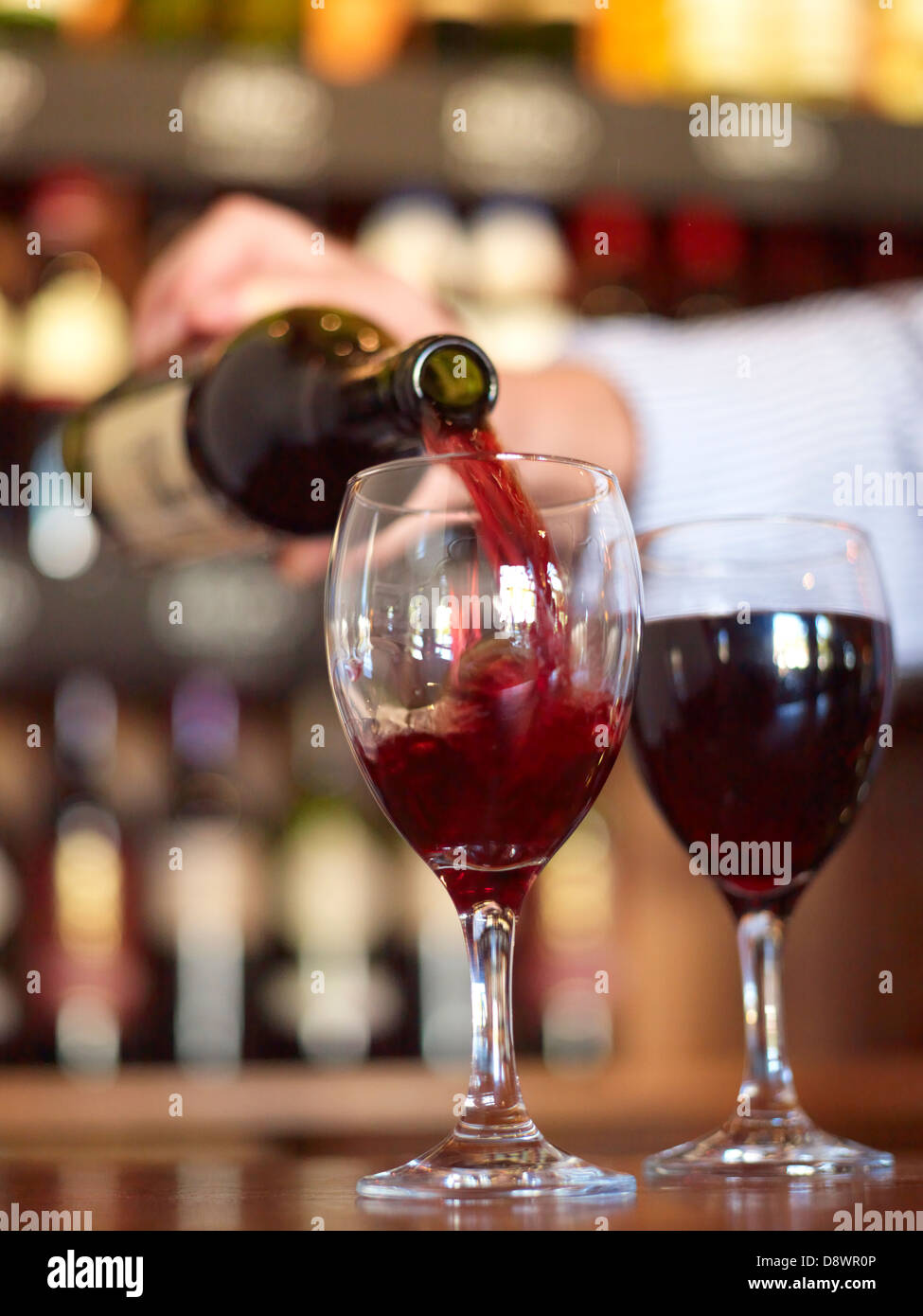 Red wine being poured into a glass Stock Photo - Alamy