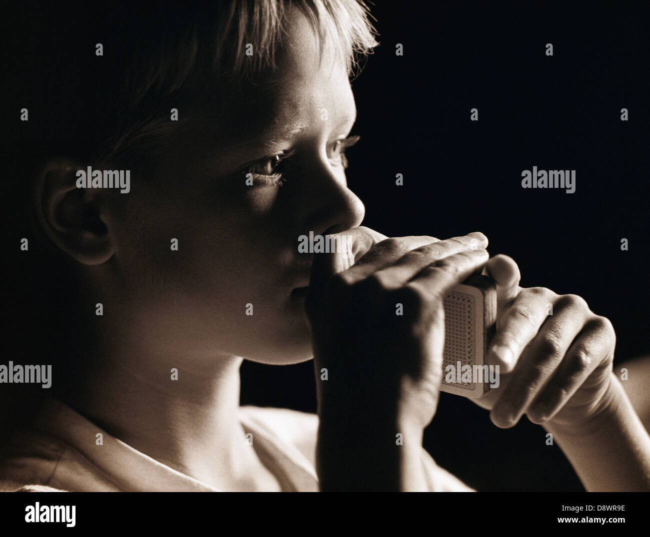 Portrait of thoughtful boy with deck of card in the hand Stock Photo ...