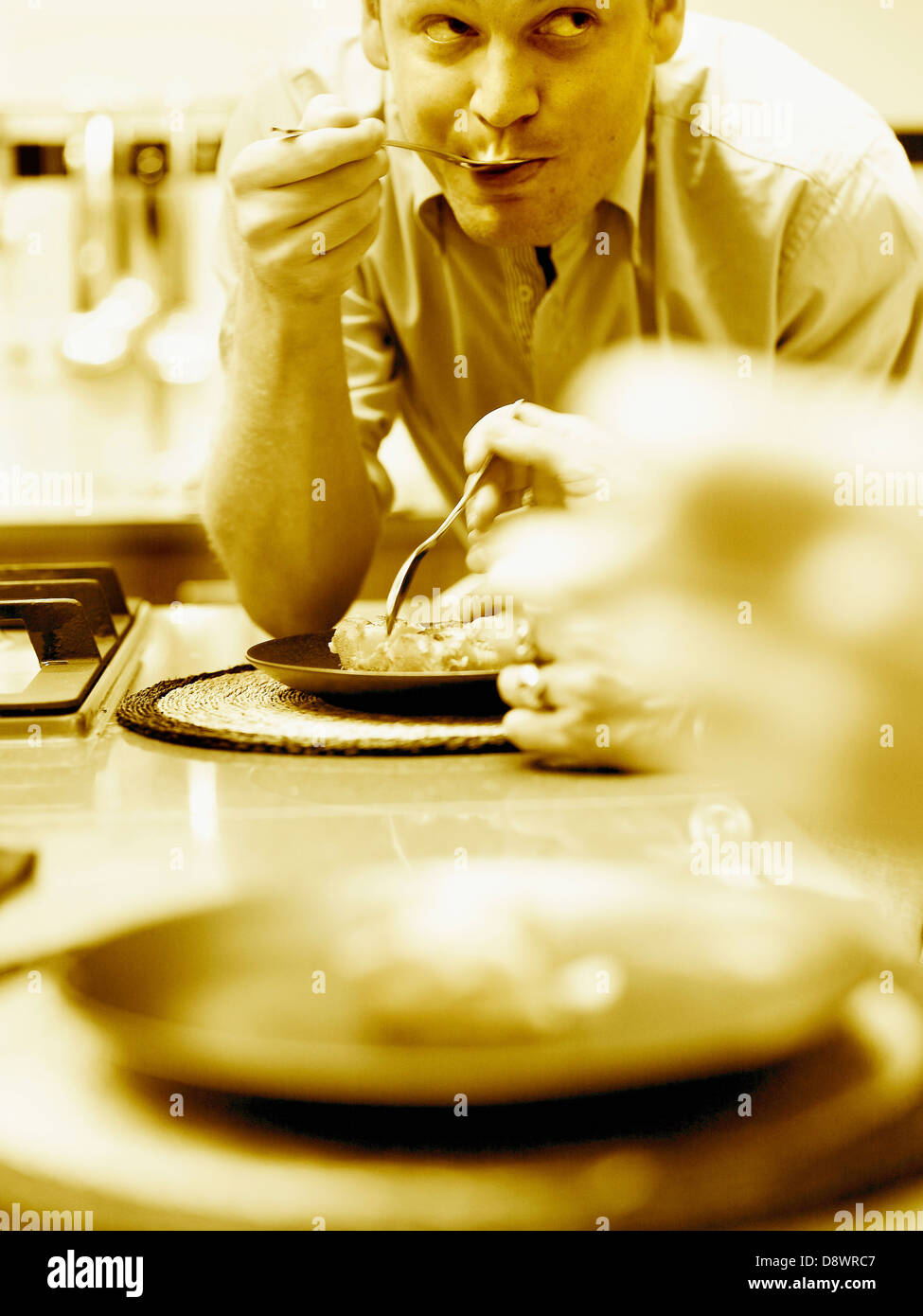 Man tasting a dish in the kitchen Stock Photo - Alamy